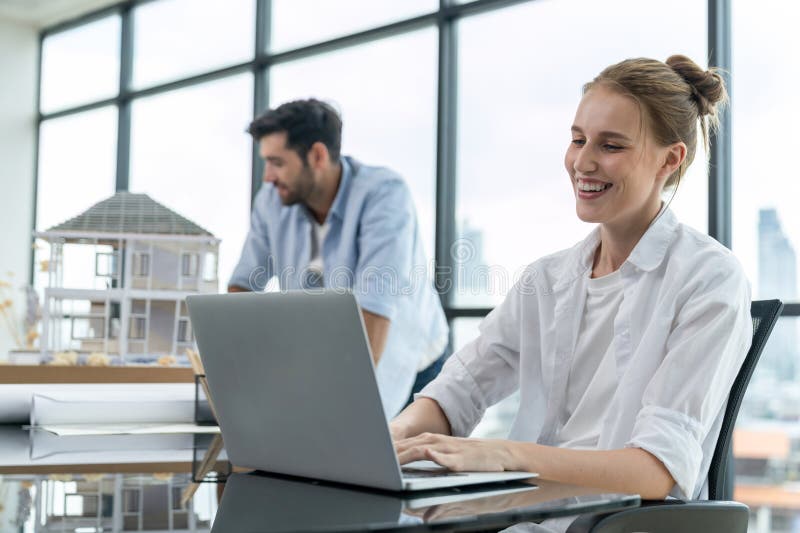 Manager Working by Using Laptop while Engineer Inspect House Model ...