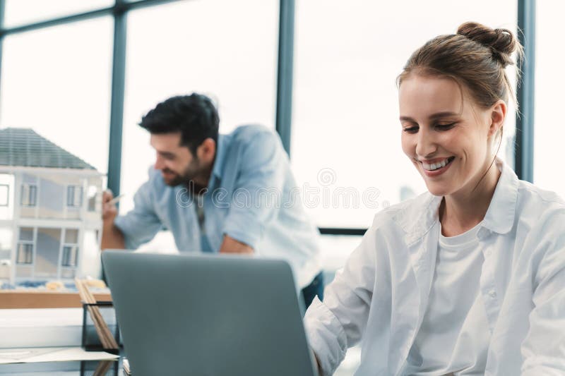 Manager Working by Using Laptop while Engineer Inspect House Model ...