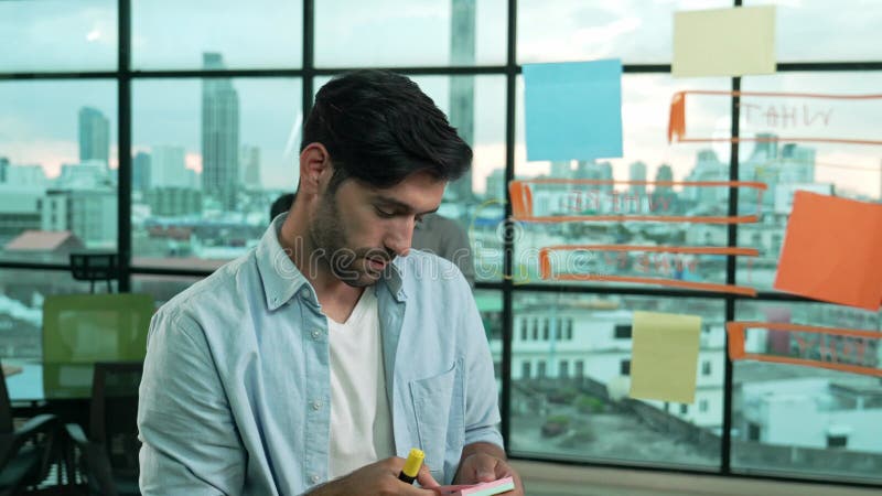 Manager Writing Sticky Notes at Glass Wall To Planning Strategy ...