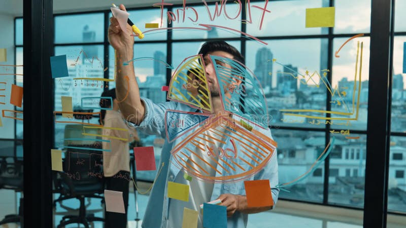 Manager Writing Sticky Notes at Glass Wall To Planning Strategy ...