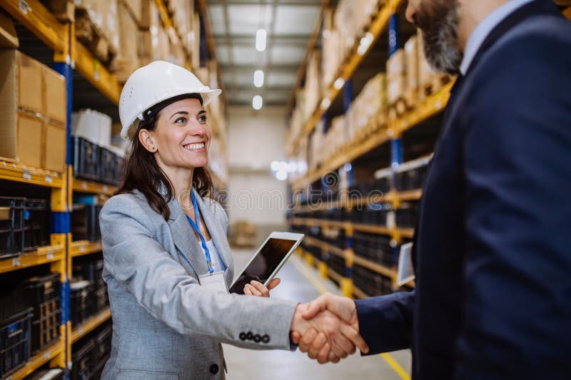 Managers in Suits Shaking Hands in Warehouse. Stock Image - Image of ...