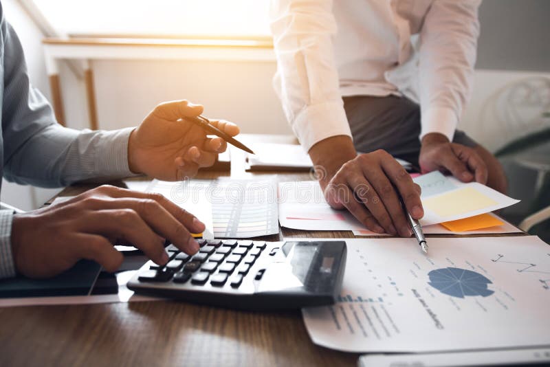 Managers Using Calculator To Analyze Sales Cost Reports and Explain ...