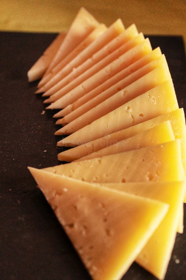 Manchego Cheese Slices in Triangles Stock Photo - Image of homemade ...