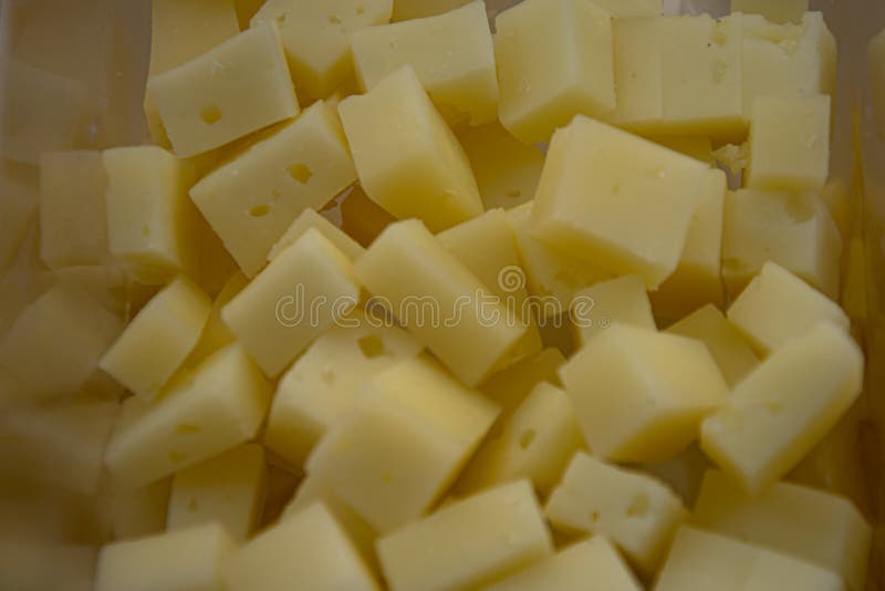 Manchego Cheese Split into Square Pieces for Tasting in the Foreground ...