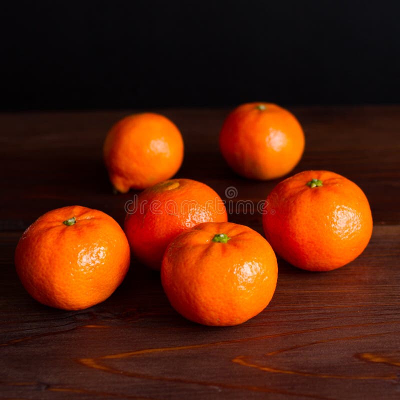 Mandarin on dark wood stock photo. Image of exotic, fresh - 85779416