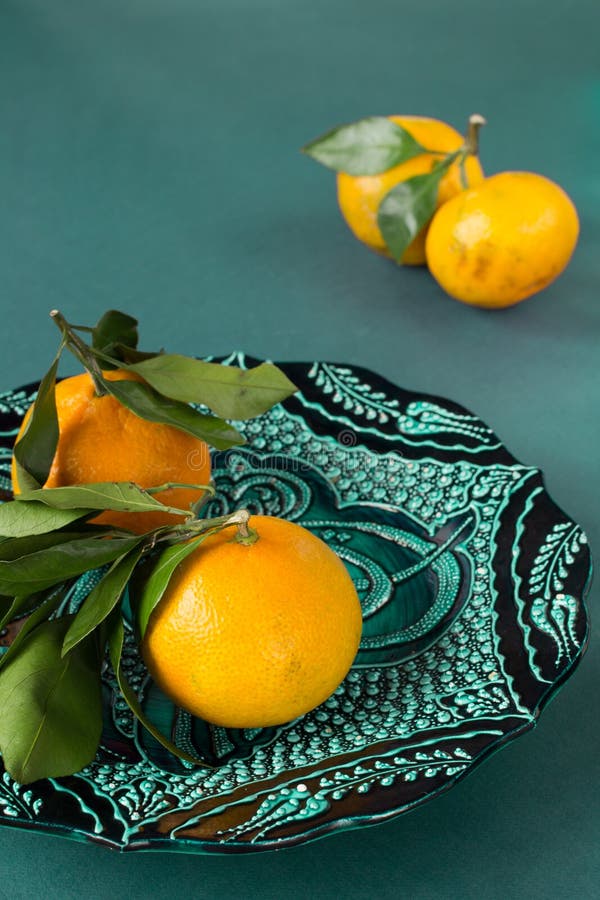 Mandarine Fruite with Leaves on Blue Turkish Ceramic Plate on a Blue ...