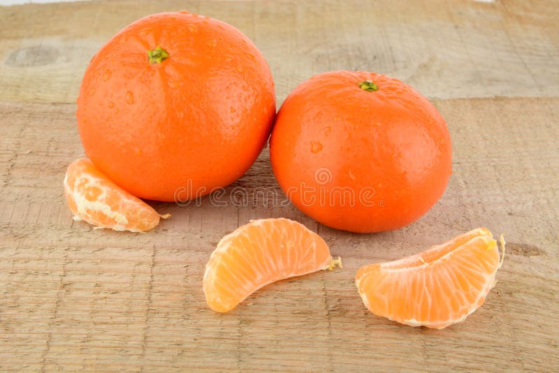 Mandarines with Pieces Isolated on Wooden Table Stock Photo - Image of ...