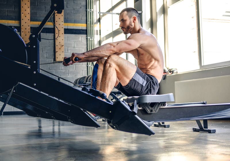 A Mandoing Workouts on a Back with Power Exercise Machine. Stock Image ...