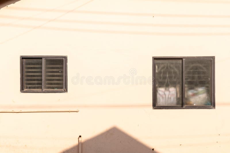 Square Windows of an Old Rustic House with Beige Walls Editorial Stock ...
