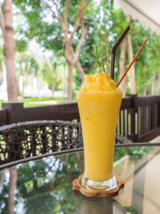 Mango Blend with Ice in a Glass on Glass Table Stock Image - Image of ...