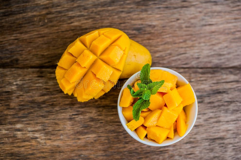 Mango Fruit and Mango Cubes on the Wooden Table. Stock Photo - Image of ...