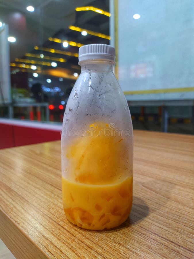 Mango Juice with Jelly Served in a Clear Plastic Bottle Stock Photo ...