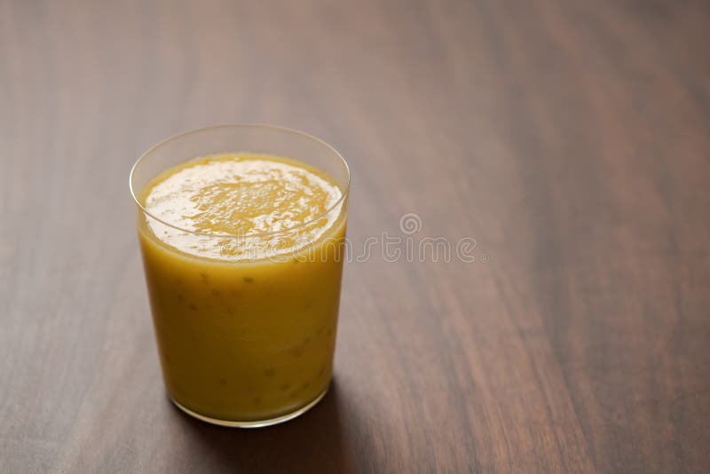 Mango Lulo Smoothie on Walnut Wood Table with Copy Space Stock Image ...