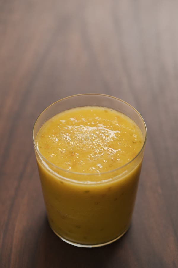 Mango Lulo Smoothie on Walnut Wood Table with Copy Space Stock Photo ...