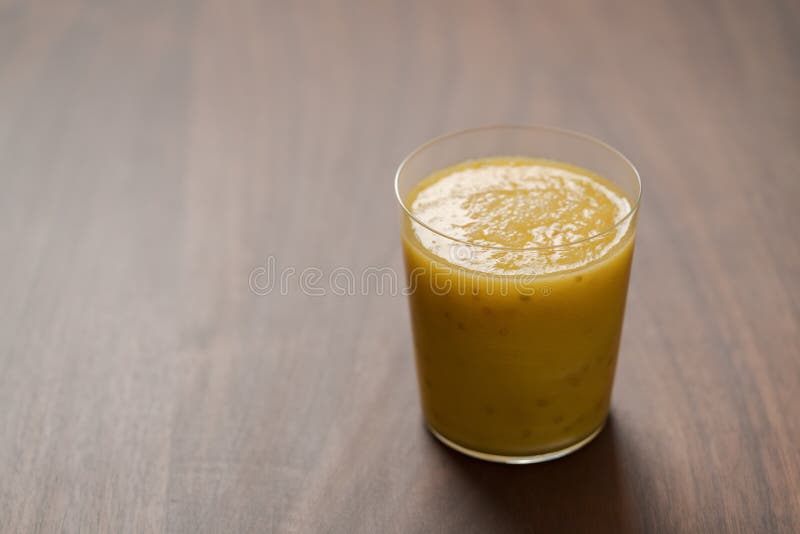 Mango Lulo Smoothie on Walnut Wood Table with Copy Space Stock Photo ...