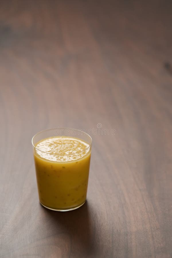 Mango Lulo Smoothie on Walnut Wood Table with Copy Space Stock Image ...