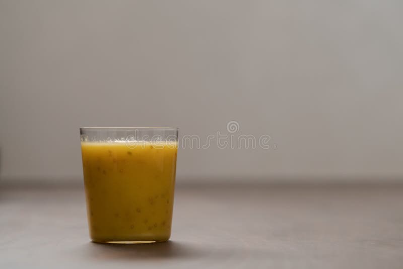 Mango Lulo Smoothie on Walnut Wood Table with Copy Space Stock Photo ...