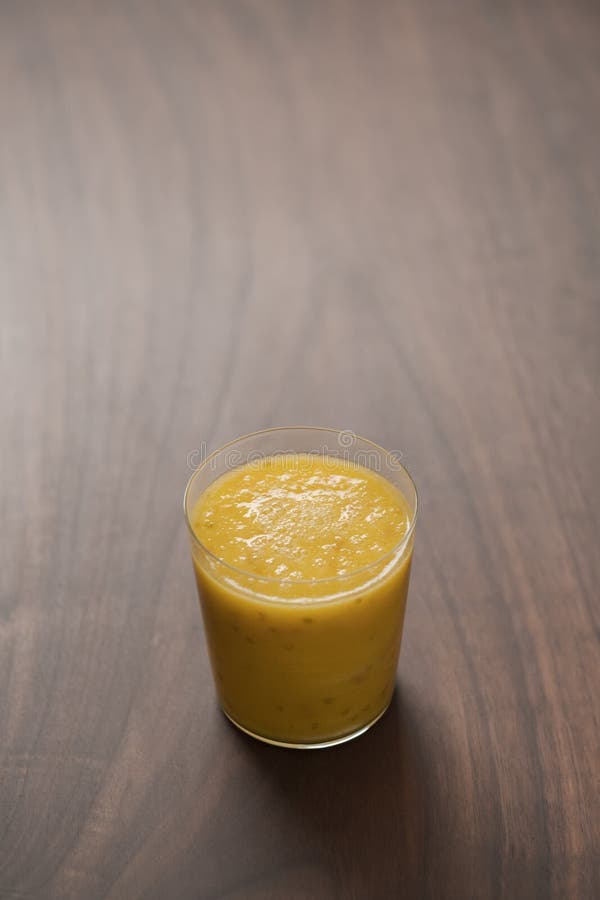 Mango Lulo Smoothie on Walnut Wood Table with Copy Space Stock Photo ...