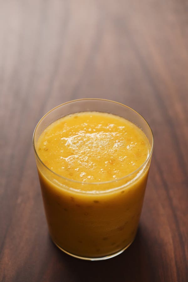 Mango Lulo Smoothie on Walnut Wood Table with Copy Space Stock Image ...