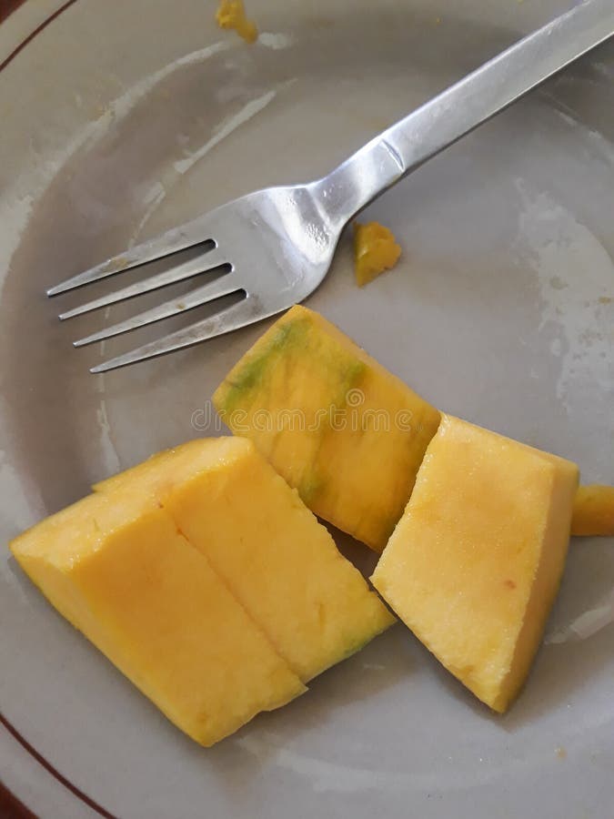 Mango Slices with a Fork on a Plate Stock Photo - Image of plate, fork ...