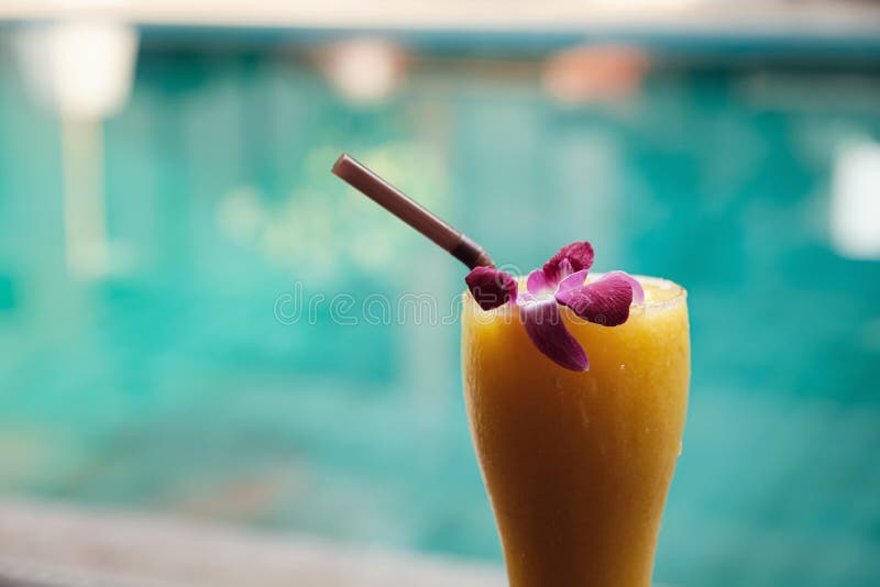 Mango Smoothie in a Tall Glass on the Background of the Pool Stock ...
