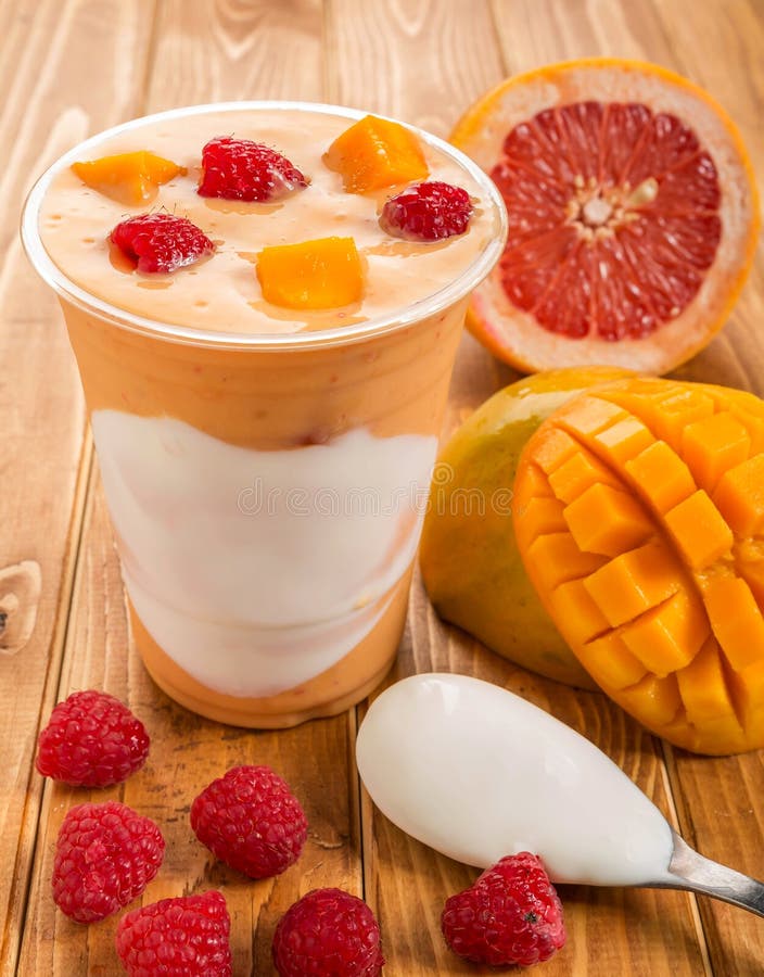 Mango Smoothie or Yogurt Parfait with Raspberries in Plastic Glass Side View of Breakfast Stock ...