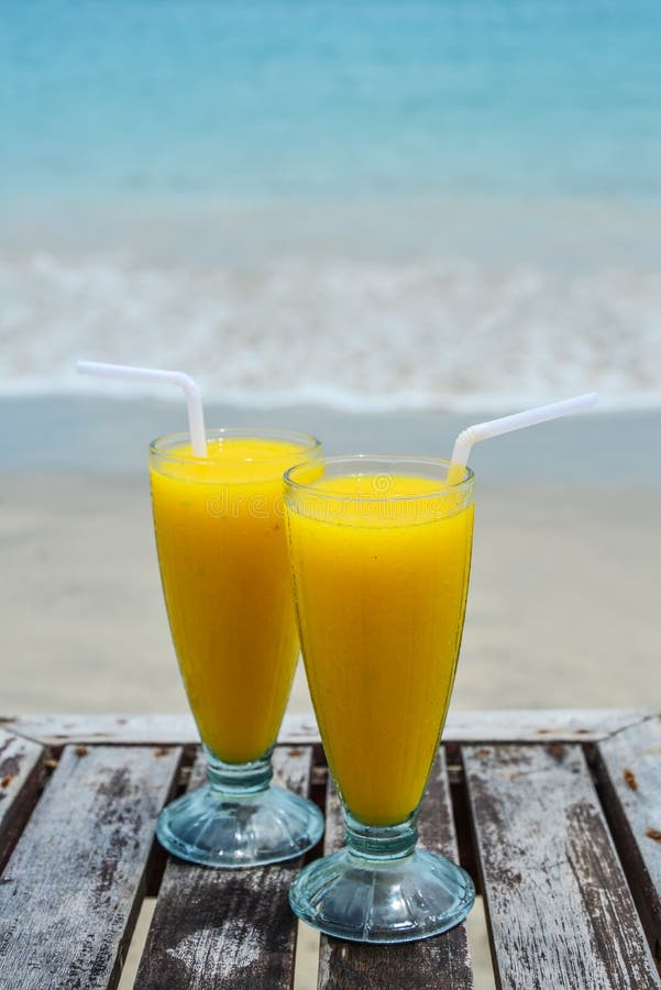 Mango smoothies at beach stock image. Image of delicious - 122387371