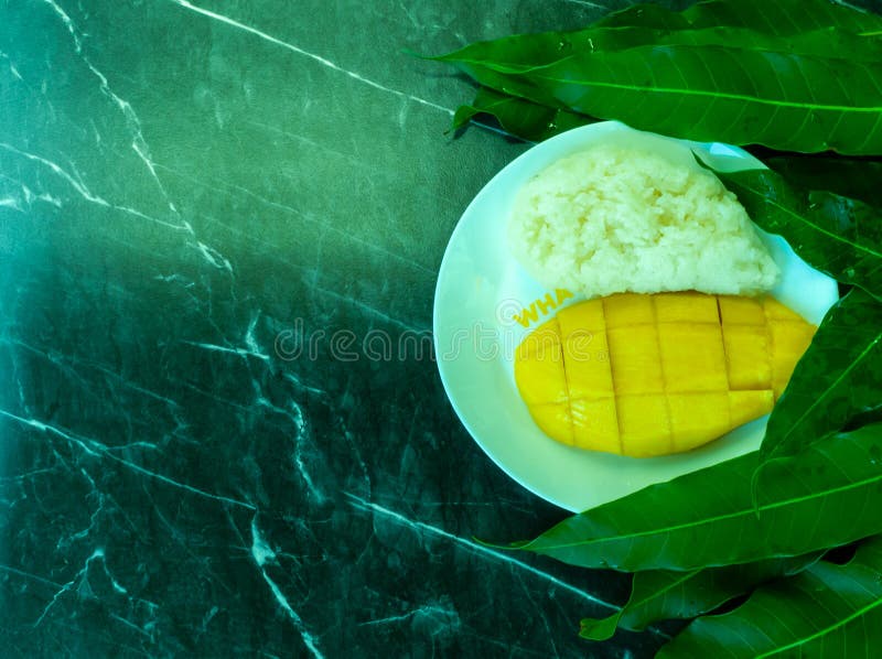 Mango Sticky Rice on a White Plate, and Mango Leaves, on a Black Marble ...
