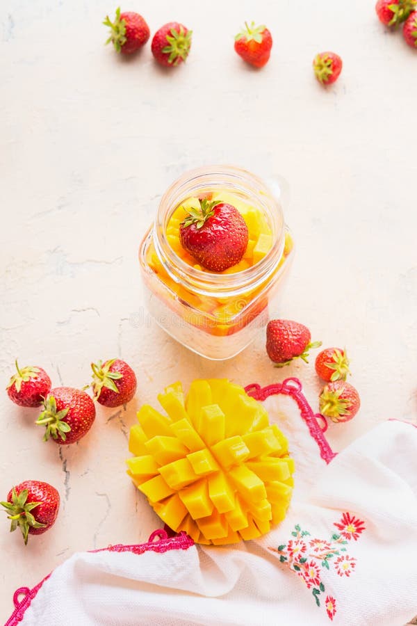 Mango and Strawberries with Yogurt Pudding in Glass Jar on White Table ...