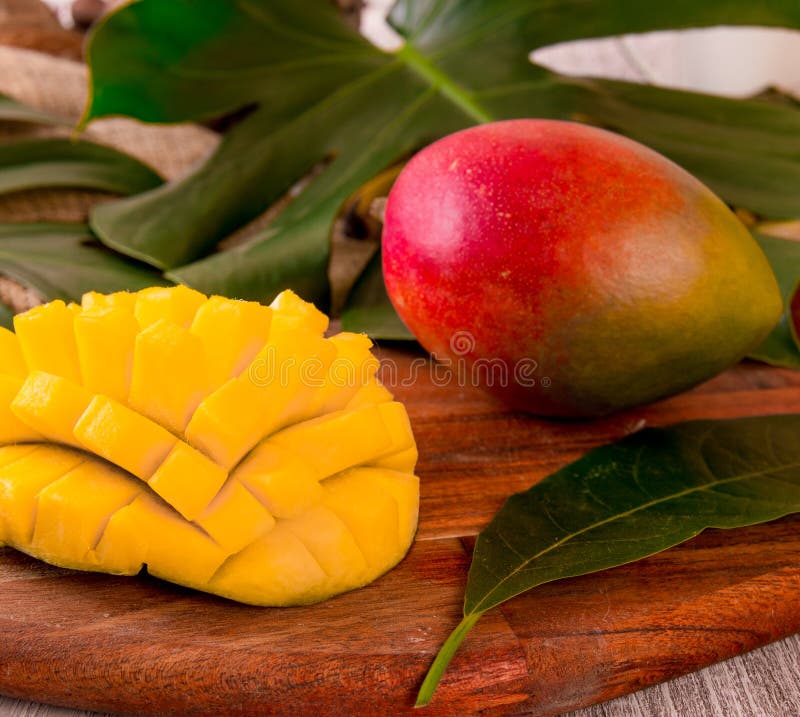 Mango. Tropical Fruits. on a Wooden Background. Blurred Background ...