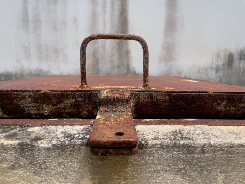 Red rust on manhole cover. stock photo. Image of temple - 231724982