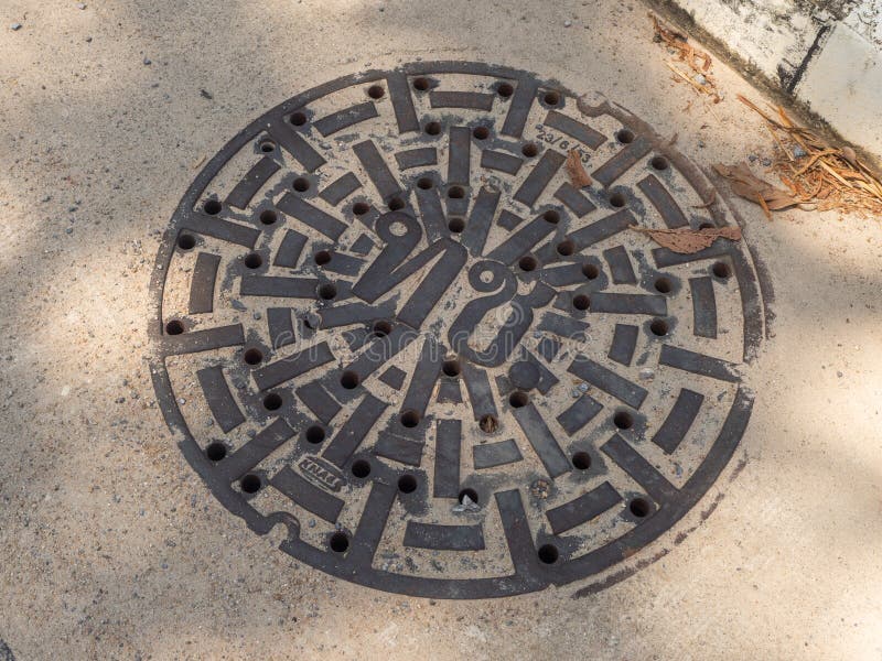 Manhole Cover on Pavement with Patterns Editorial Stock Image - Image ...