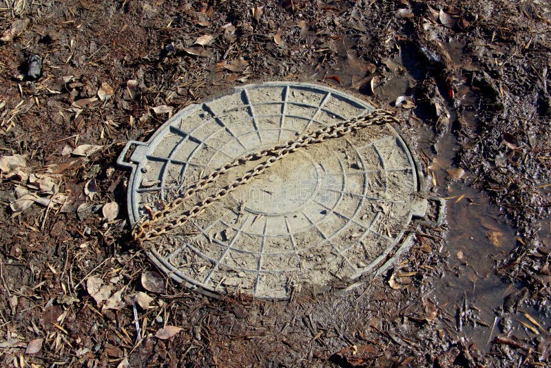 Manhole Cover Secured with Old Rusty Chains Stock Photo - Image of ...