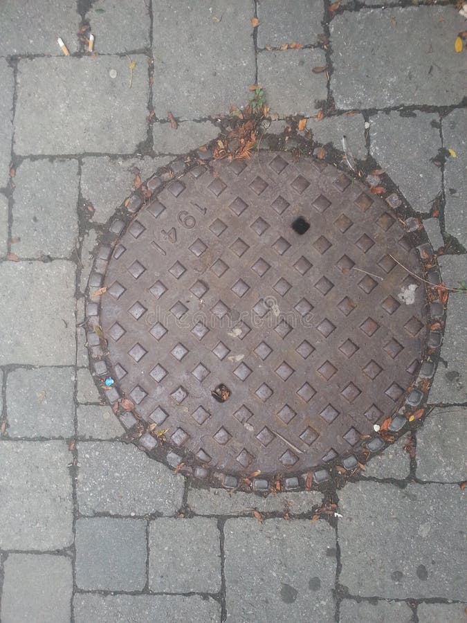 Small Manhole Cover With A Metal Ring In Midst Of A Green Field Stock ...