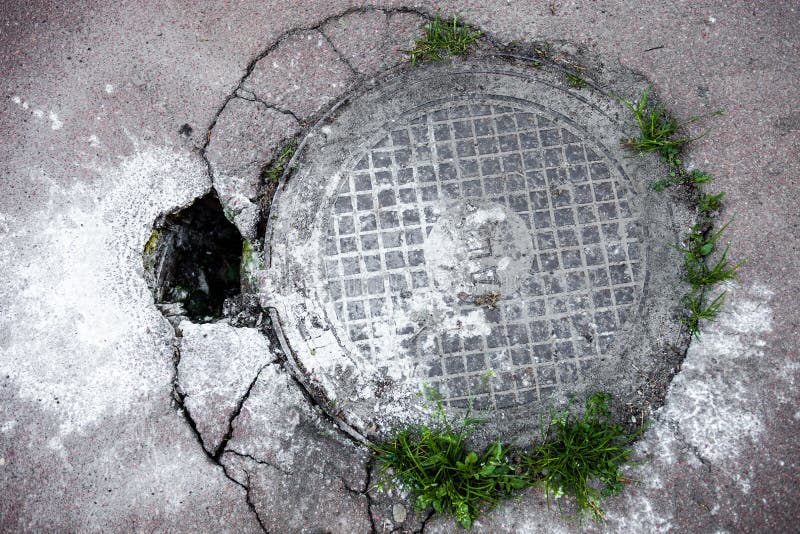 Manhole in Cracked Asphalt Surface Stock Photo - Image of industry ...