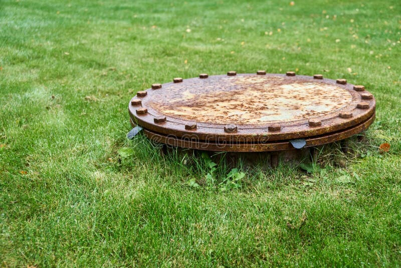 Manhole on the grass stock photo. Image of green, grid - 83002914