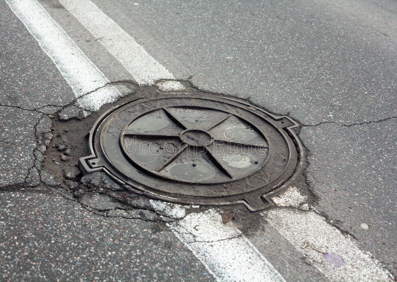Manhole on the road stock image. Image of iron, marking - 61259027