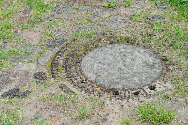 Manhole of a Sewer or Drain with a Plastic Round Cover Surrounded by ...