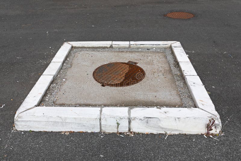 Manhole In The Curb Line Between The Grass And Asphalt Stock Photo ...