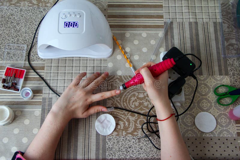 Manicure Master Works with Nails with a Manicure Machine Stock Image ...