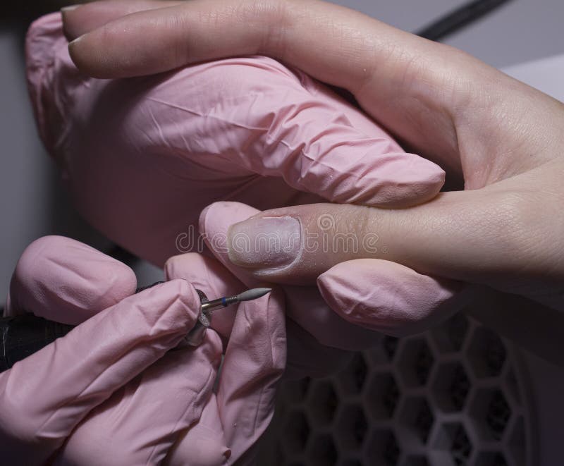 The Manicurist Processes the Client`s Cuticle with a Hardware Machine ...