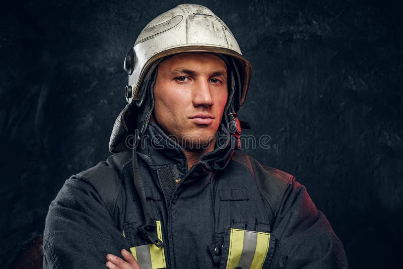 Brutal Firefighter Looks Sideways and Holds a Helmet in His Hand Stock ...