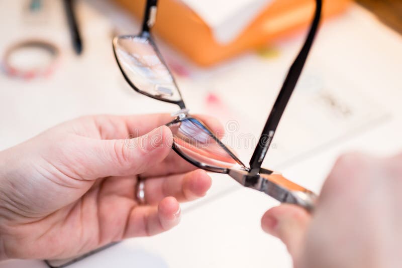 Mann Assembling Frame and Lens of New Spectacle Glasses Stock Photo ...