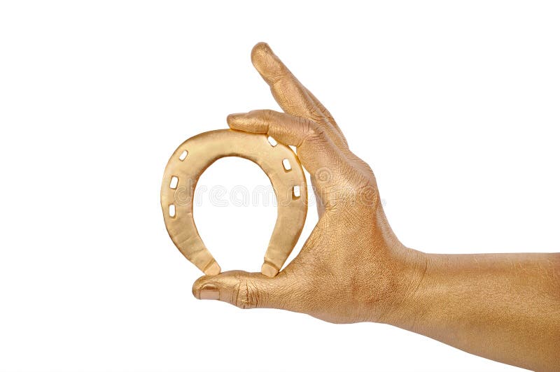 Mano De Oro Con La Herradura Del Oro. Imagen de archivo - Imagen de ...