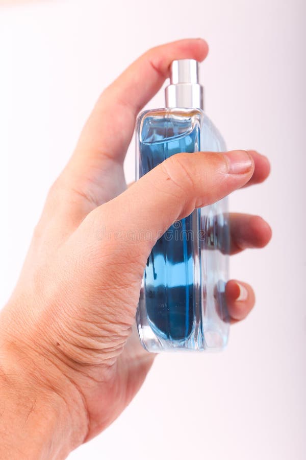 Mano Que Sostiene Perfume De Los Hombres Imagen de archivo - Imagen de ...