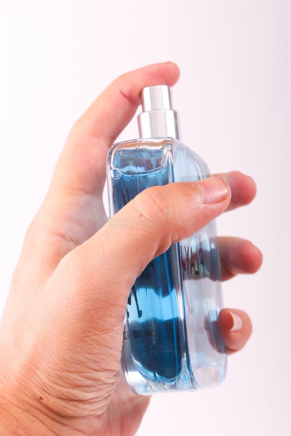 Mano Que Sostiene Perfume De Los Hombres Foto de archivo - Imagen de ...