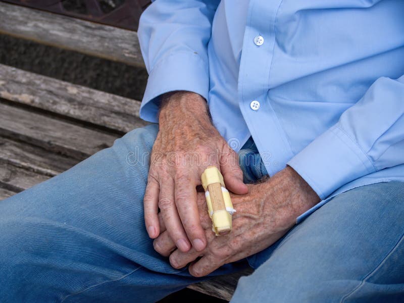 Mans Hand with an Improvised Splint on Finger. Do it Yourself First Aid ...