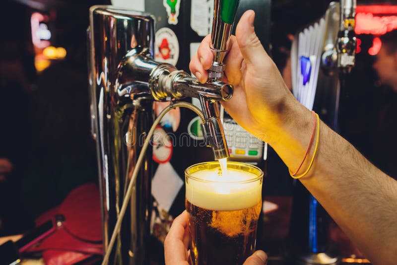 Mans Hand Pouring Pint of Beer Behind the Bar. Stock Image - Image of ...