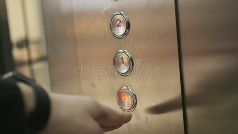 Mans Hand Presses Elevator Button To Move Down. View Inside Glass ...