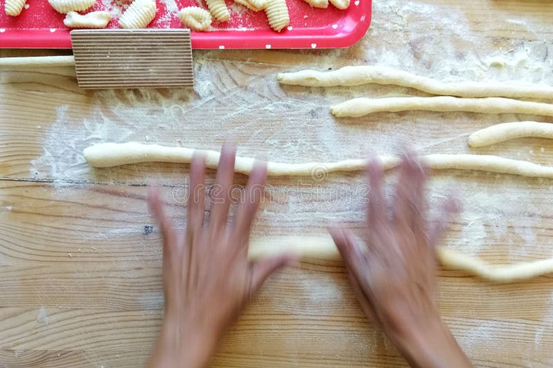 Mans hand rolling a dough stock photo. Image of closeup - 255980480